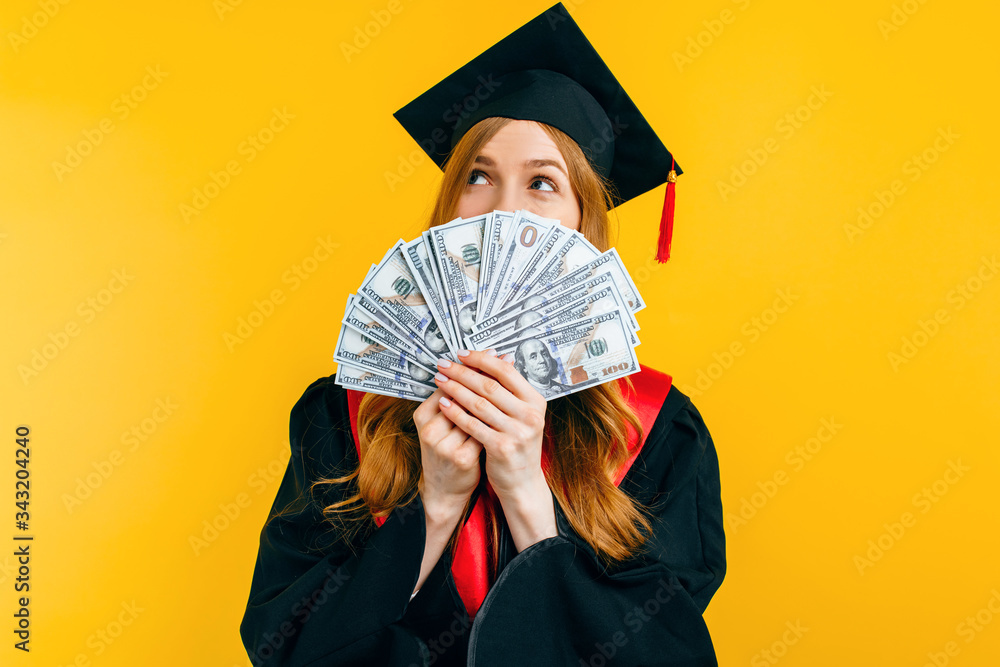 beautiful graduate girl, in a black gown, and a black master's hat ...