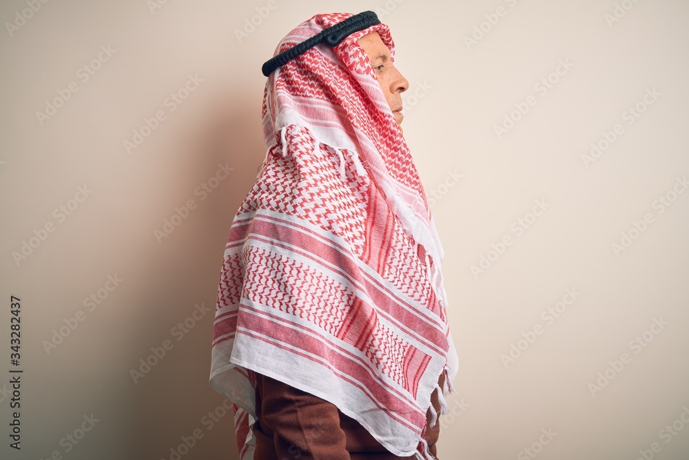 Senior handsome arab man wearing keffiyeh standing over isolated white ...