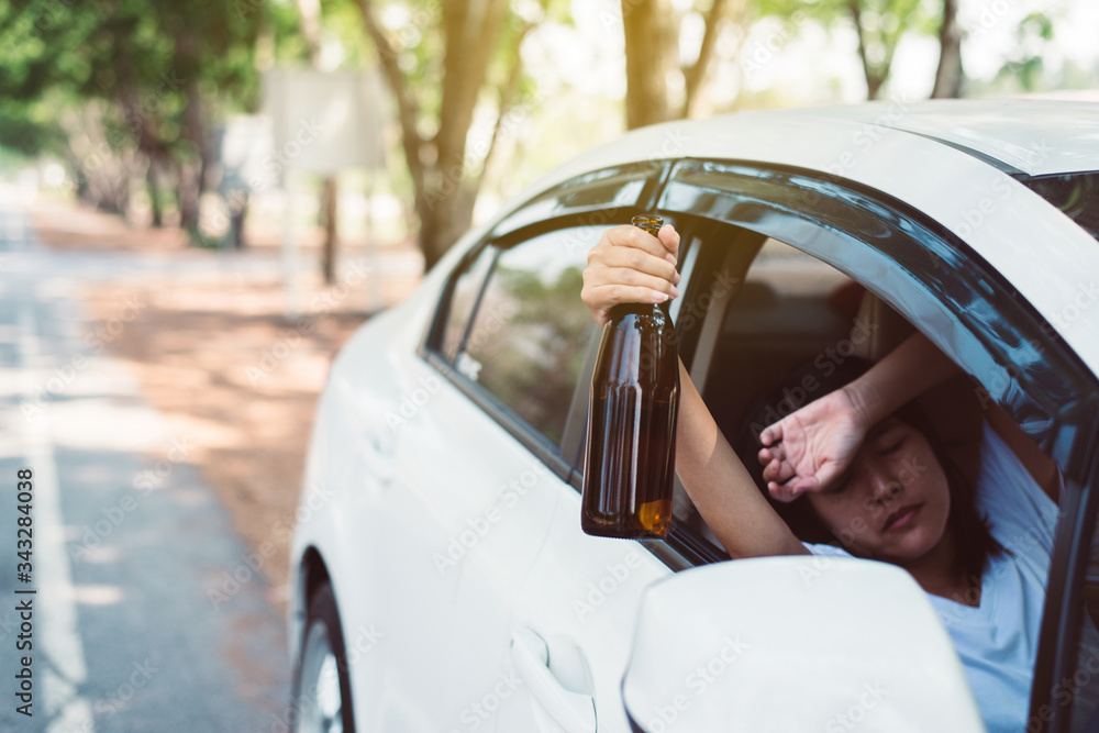 Drunk asian women drinking alcohol while driving car on road,Woman ...