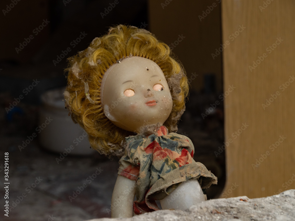 A doll in an abandoned kindergarten building after the explosion of the ...