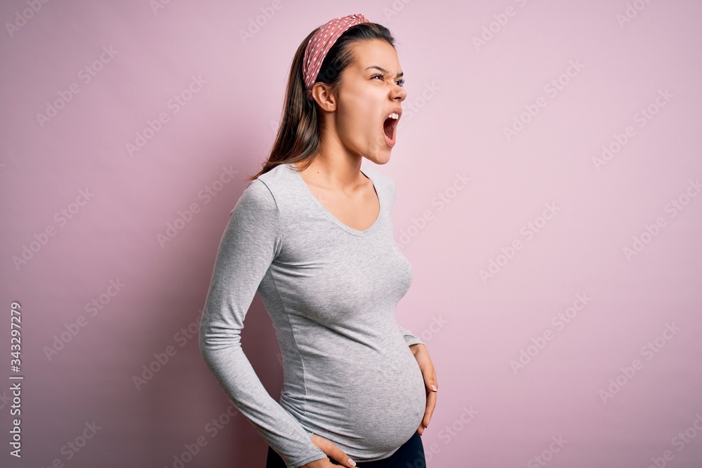 Young beautiful teenager girl pregnant expecting baby over isolated ...
