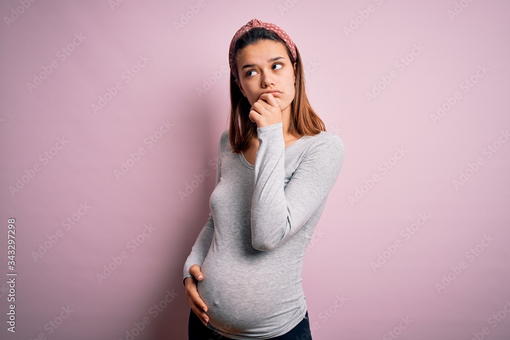 Young beautiful teenager girl pregnant expecting baby over isolated ...