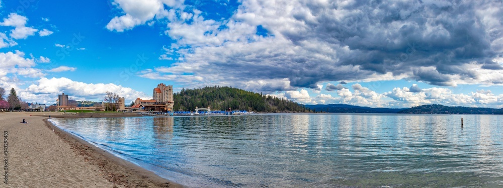 Coeur d'Alene beach with resort and cloudy sky background Stock Photo ...