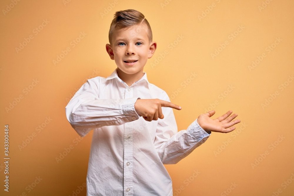 Young little caucasian kid with blue eyes wearing elegant white shirt ...