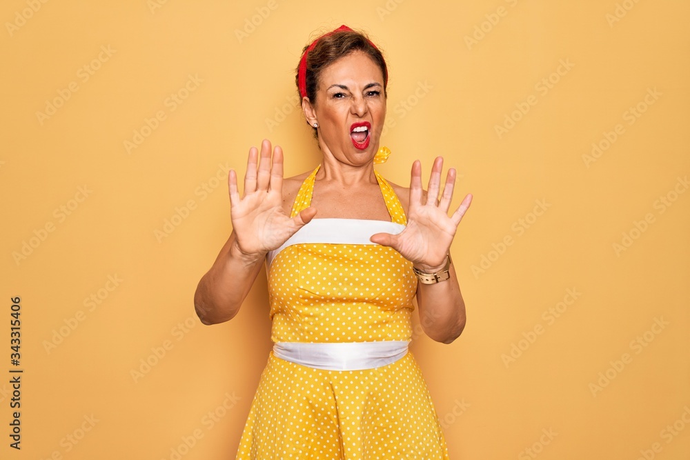 Middle age senior pin up woman wearing 50s style retro dress over ...