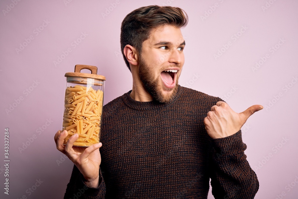 Young blond man with beard and blue eyes holding bottle of Italian dry ...