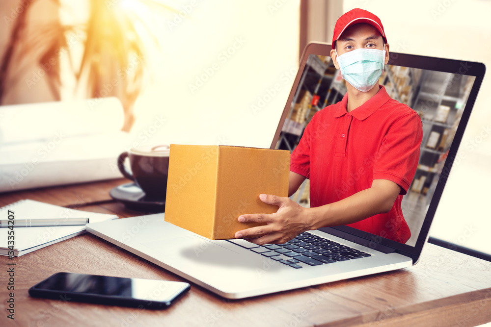 delivery man in red shirt with hygienic mask, holding goods order in ...