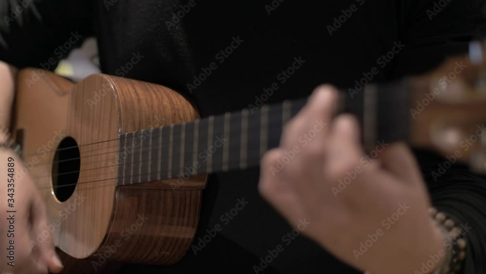 Another chords. String Cuatro instrument recording session, closeup ...