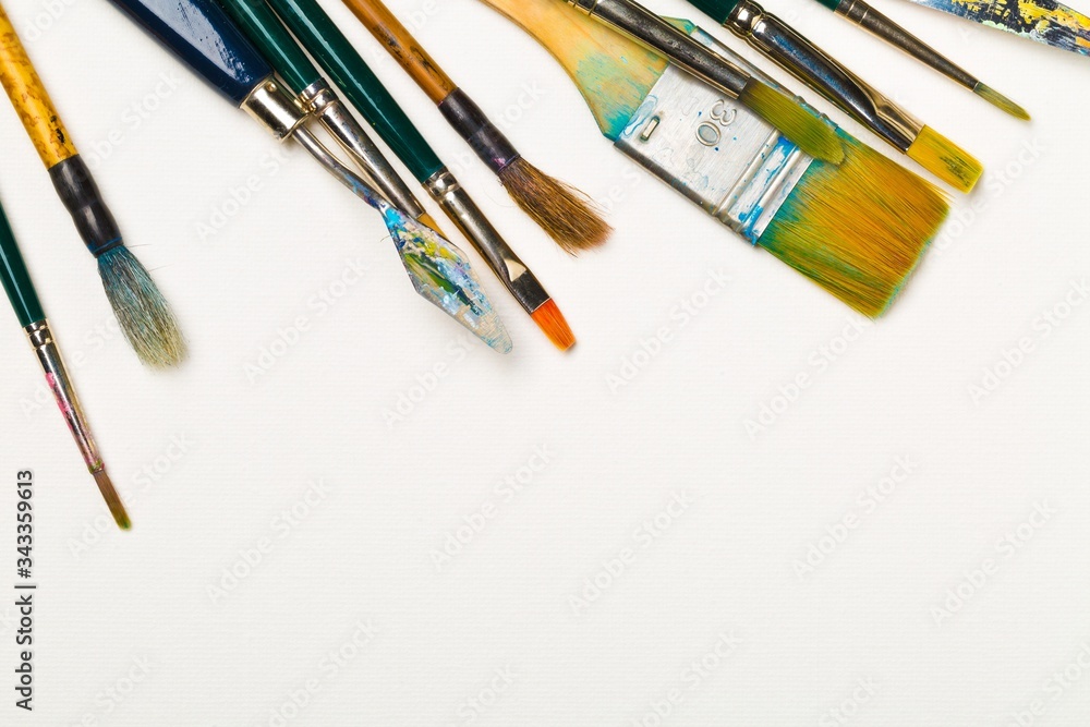 Artistic art supply utensils with brushes on white background with copy ...