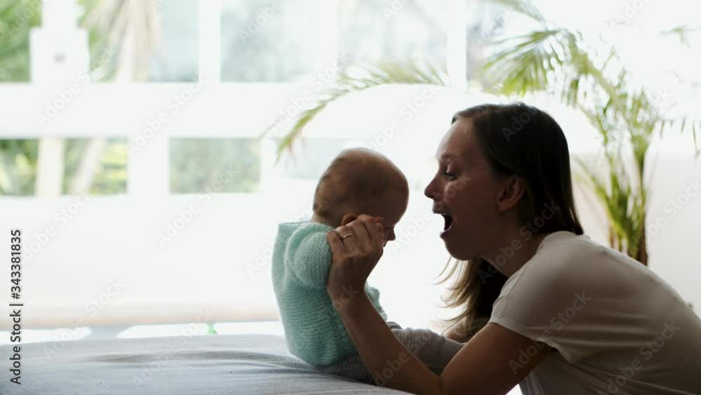 Vidéo Stock Joyful excited mom helping baby daughter to sit up. New ...