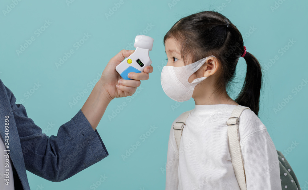 Mom and Asian little child girl wearing respirator mask to protect ...