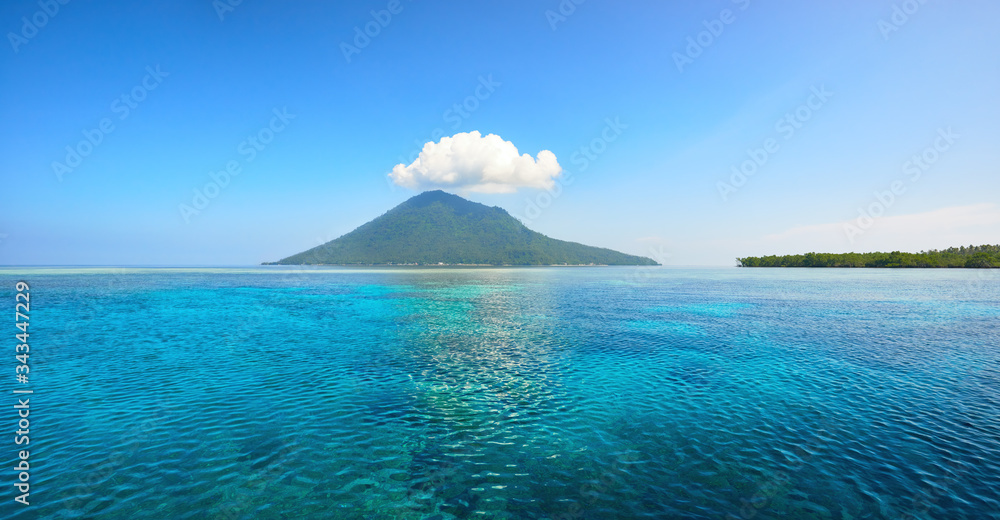 Beautiful panoramic view of volcanic island of Manado Tua on summer day ...