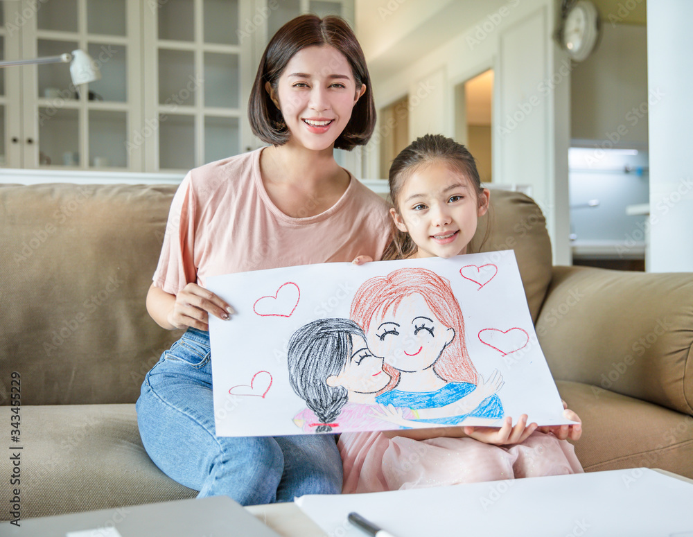 little girl showing Color pencil drawing family picture to her mother ...