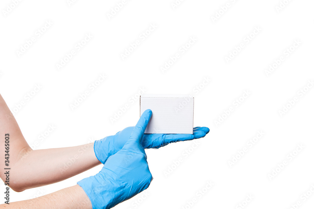 hands in blue sterile latex gloves holds white un label cardboard box ...