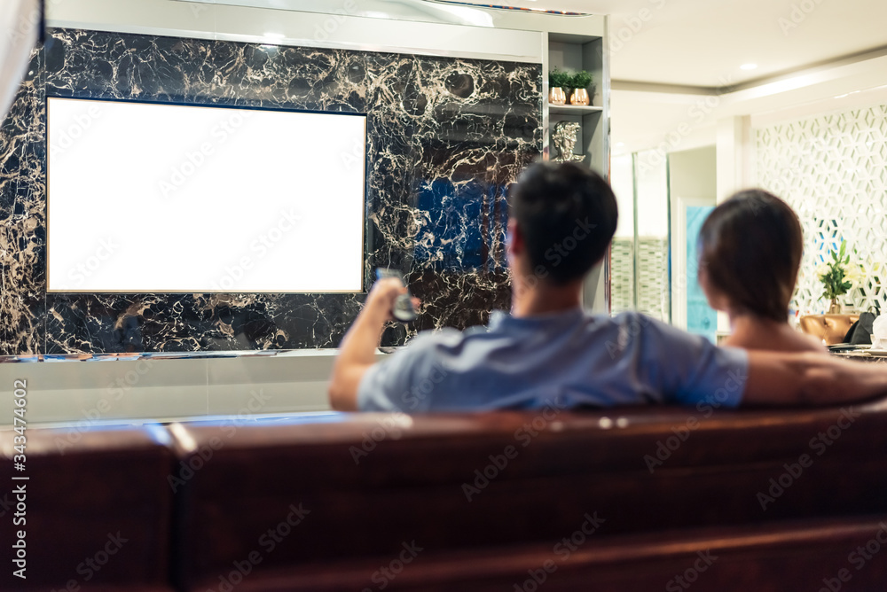 Asian couples watching white blank screen display television for ...