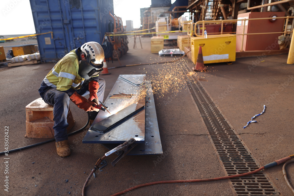 Safe work practices worker setting wearing a safety helmet, red welding ...