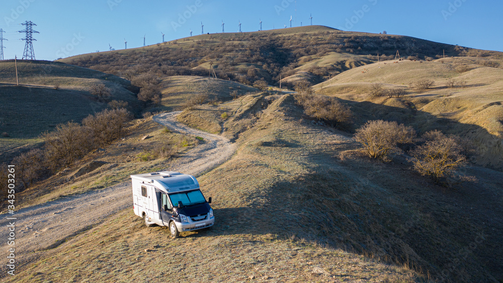 Caravan camper motorhome or camping home van car on the winding rural ...