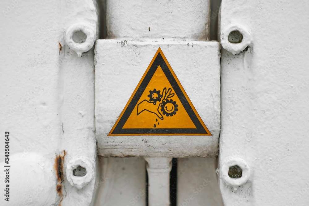 Warning sign about hands trapped between gears of a sluise gate Stock ...