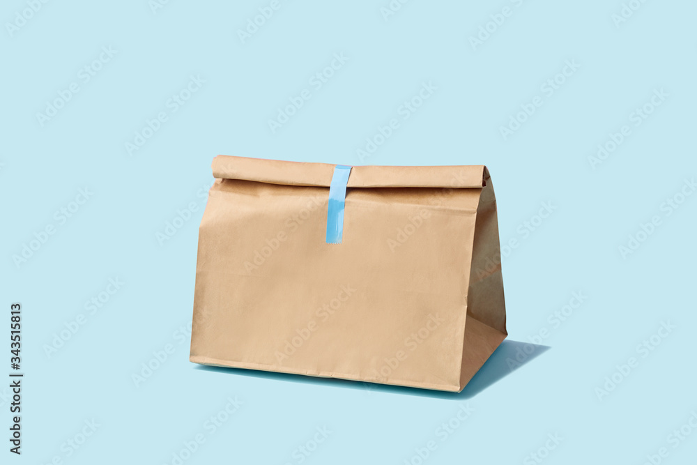 Brown clear empty blank paper bag for food delivery on blue background ...