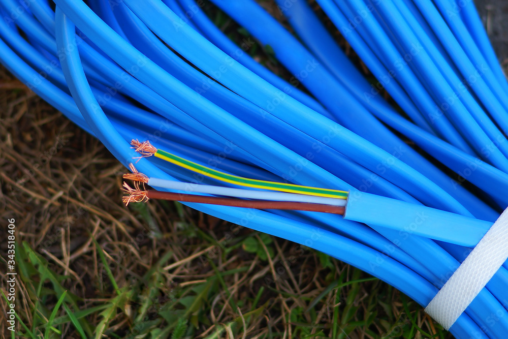 A blue submersible cable lies on the ground. Electrical cable with ...
