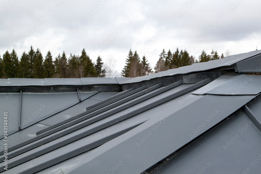 close-up view of an independent black metal folding roof and ...