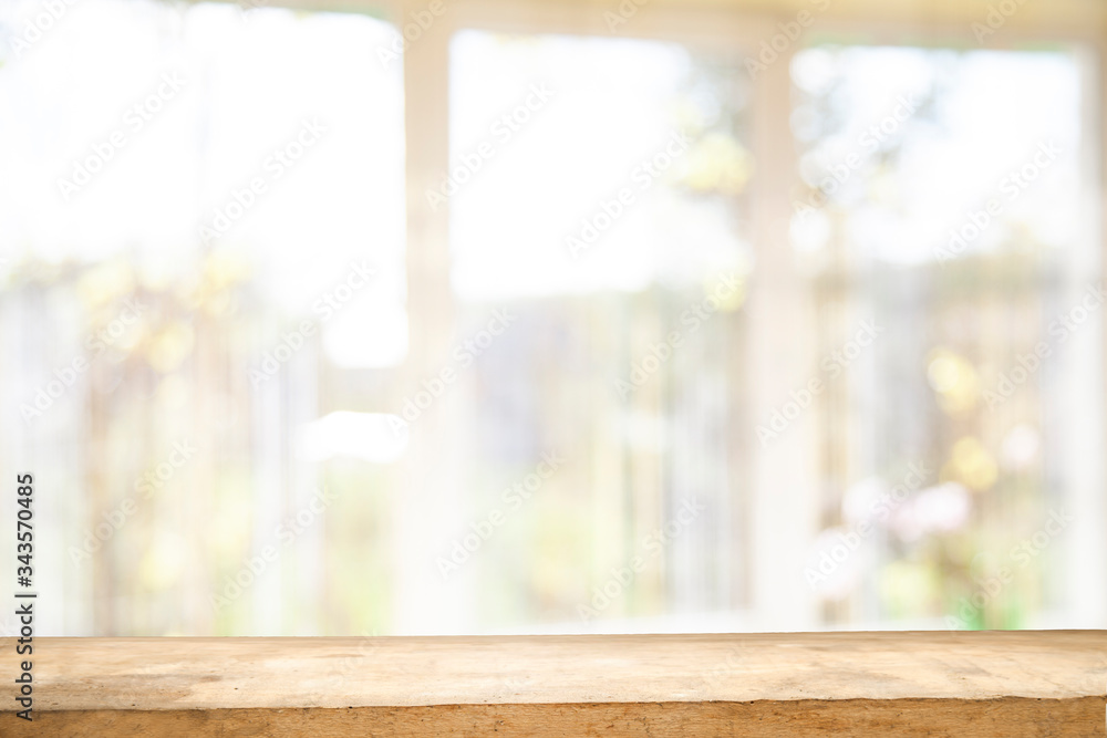 Top of wooden table on window glass blur. Of green from the garden of ...
