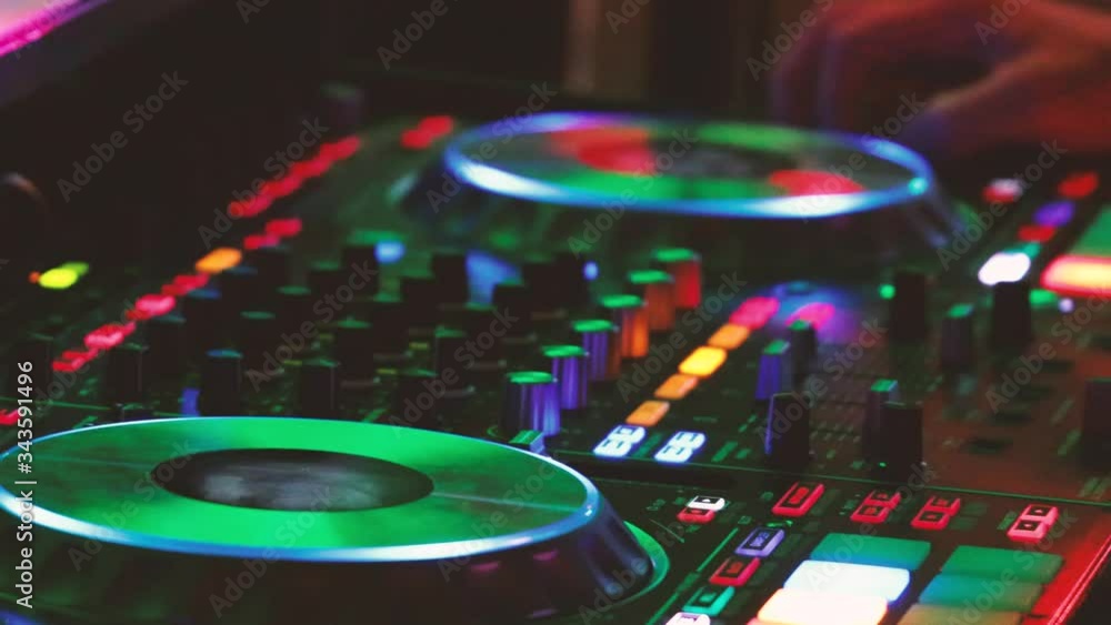 Close Up DJ hands playing music on sound console at dance party in ...