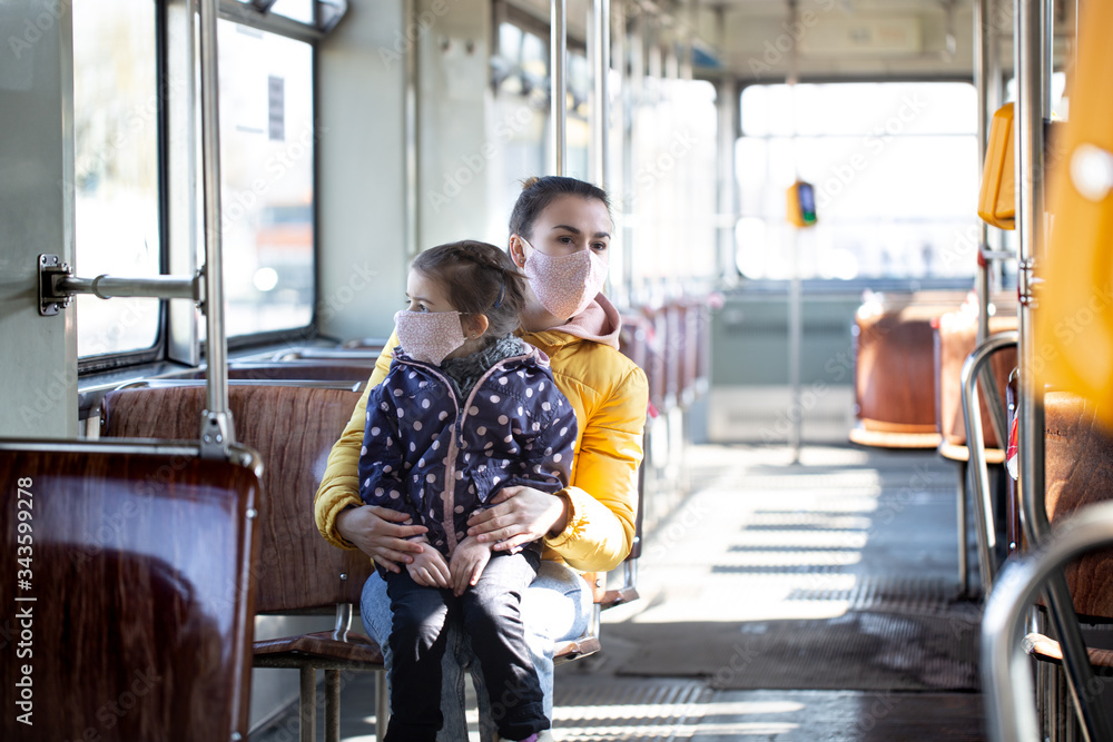 Mother and child in public transport, wearing masks . during a pandemic ...