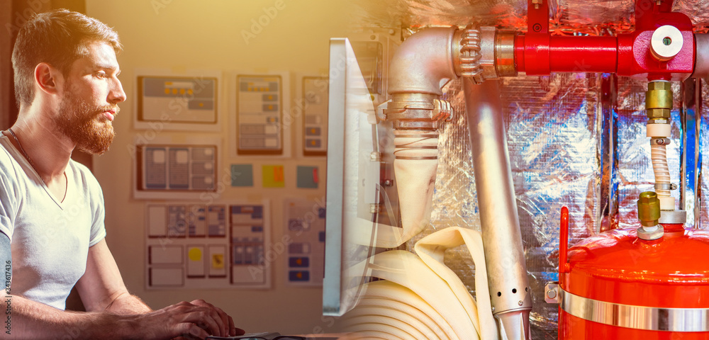 A man at the monitor against the background of fire extinguishing ...