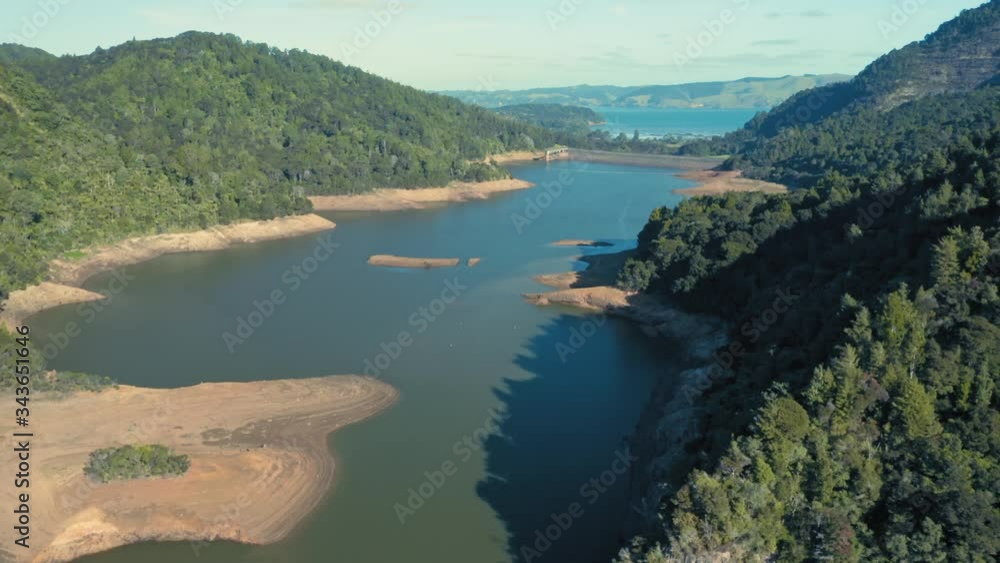 Huia Dam, Auckland, New Zealand, 2020. Aerial flying over spillway and ...