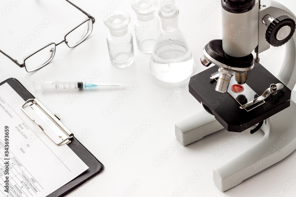 Microscope medical reserch. Blood sample for analysis. White table copy ...
