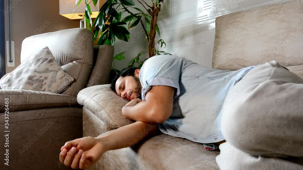 man sleeping peacefully on his couch at home Stock Video | Adobe Stock