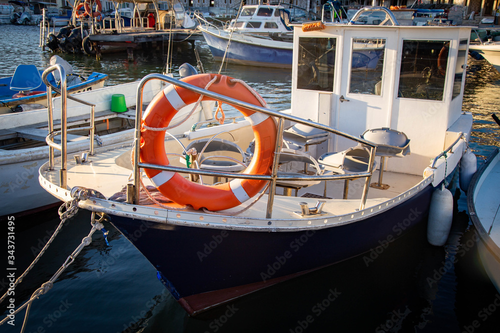 A sea boat with an orange circle for rescuing people on the water is ...