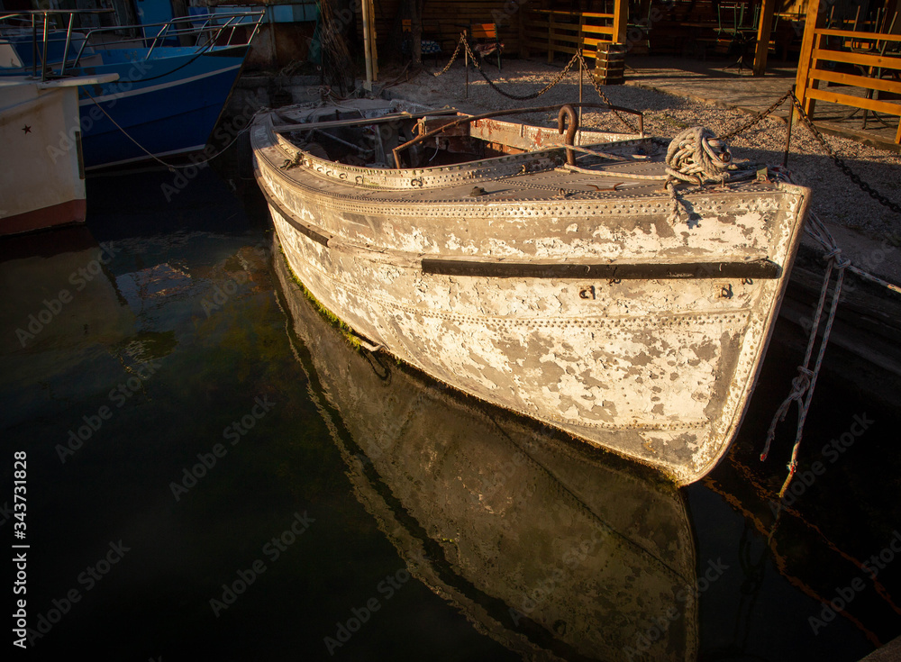 The sea boat is old and rusty, standing on the dock. Concept of water ...