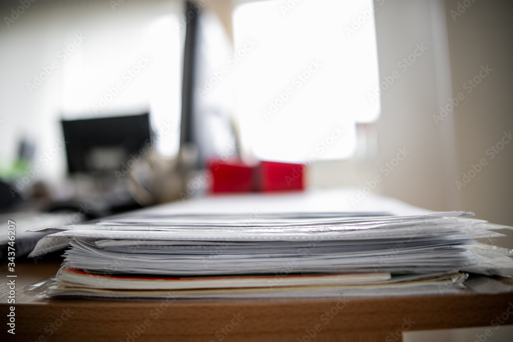 Pile of documents on desk stack up high waiting to be managed. Stock ...