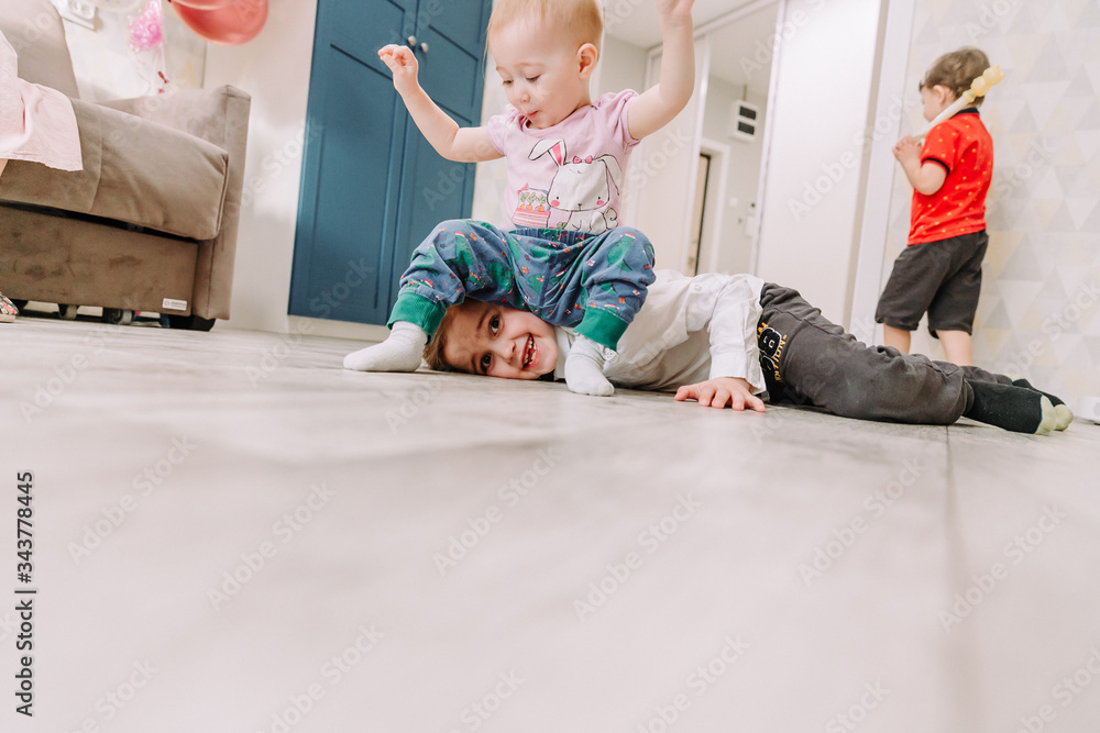 three happy children have fun at home Stock Photo | Adobe Stock