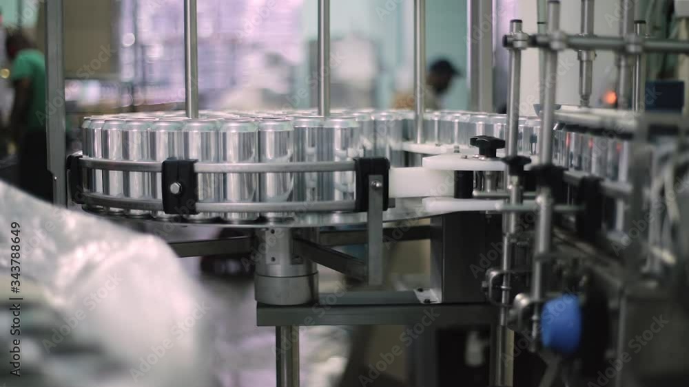 Technological line for bottling of beer in brewery. Empty aluminum beer ...