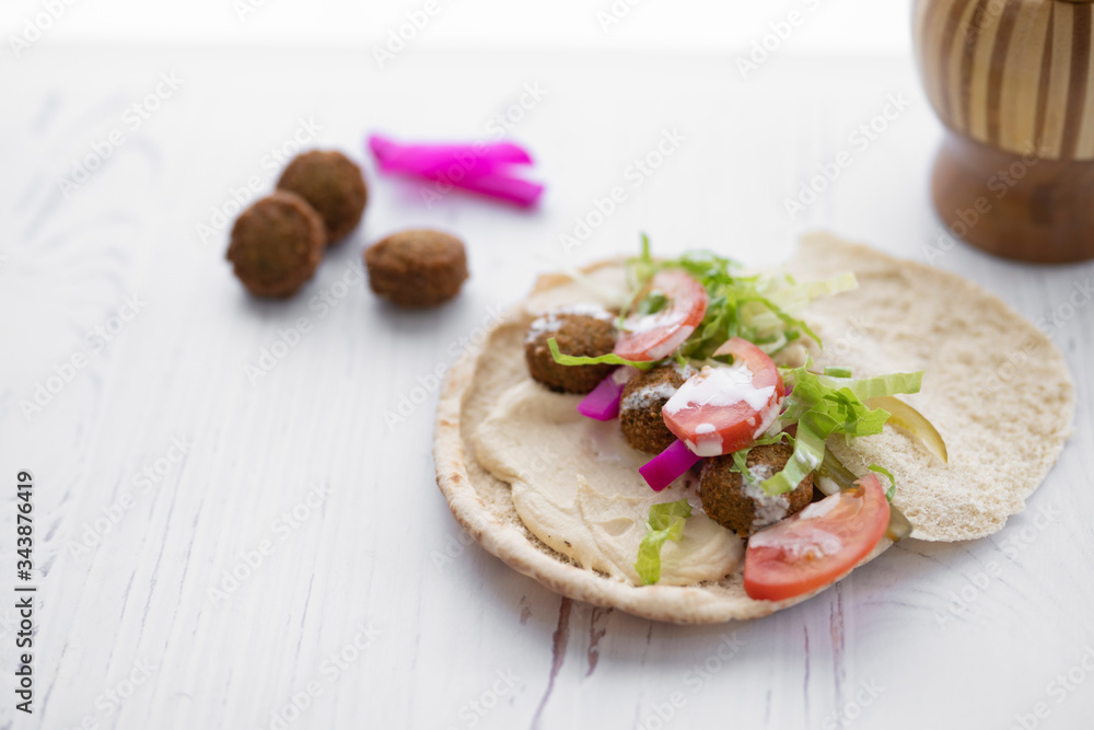 arab breakfast with hummus and falafel and fattah and foul on white ...