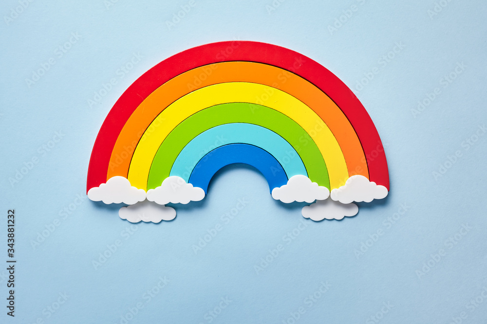 Vintage flat card with rainbow with white clouds on blue background ...