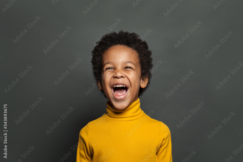 Photo & Art Print Happy black child boy laughing on black background ...