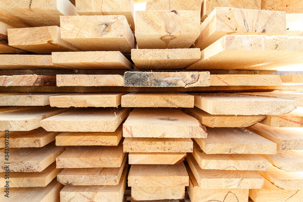 Stack of new wooden studs at the lumber yard. Timber on the ...