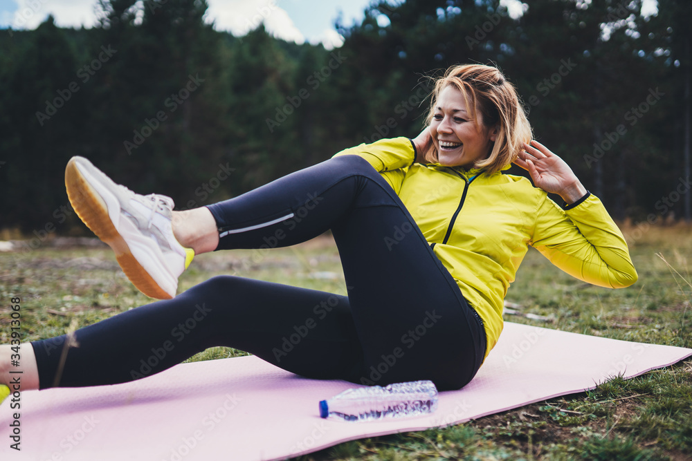 Smile girl exercising outdoors in green park, activity pose with ...