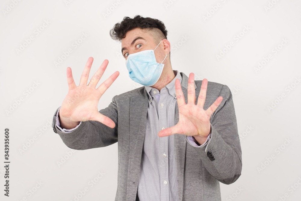 Dissatisfied male model frowns face, has disgusting expression, shows ...