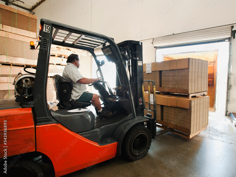 Forklift truck loading pallets into trailer Stock Photo | Adobe Stock