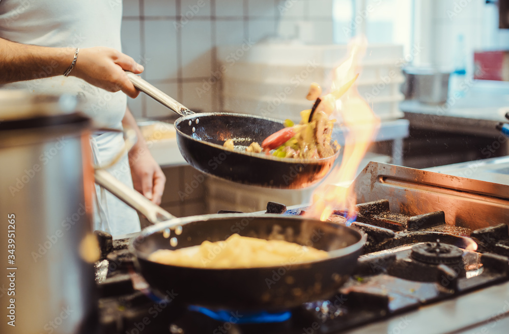 Chef cooking in a restaurant kitchen Stock Photo | Adobe Stock