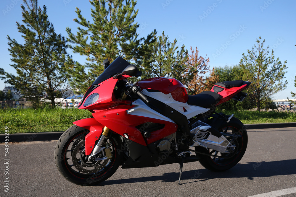 Side view of the red sport motorcycle standing alone on the parking ...