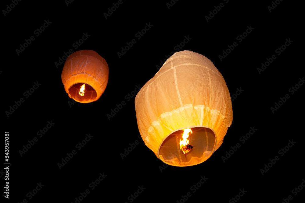 Colorful circle paper floating lanterns are flying to dark night skies ...