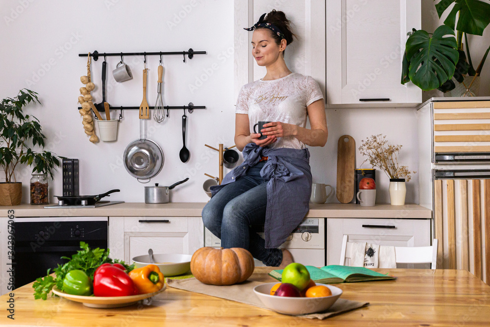 Young and beautiful housewife woman cooking in a white kitchen Stock ...
