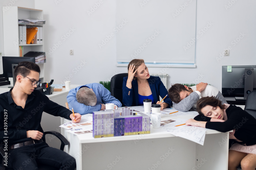 Exhausted office workers resting on their workplace, while having a 5 ...