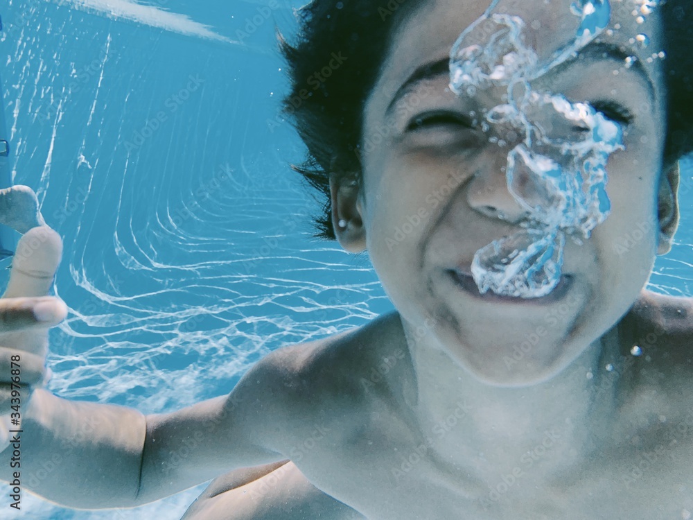 Underwater view of kid playing in a swimming pool Stock Photo | Adobe Stock